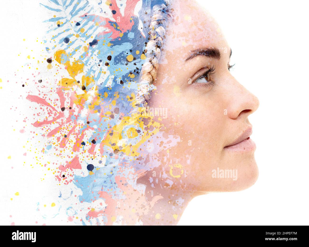 A portrait of a woman combined with digital art in a double exposure ...