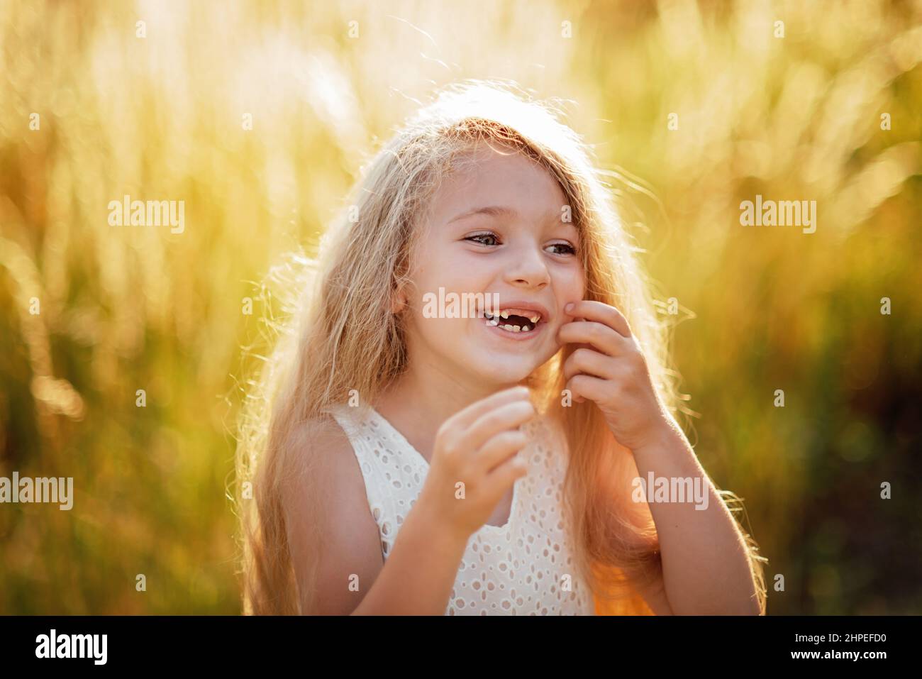 Close up portrait of beautiful joyful blonde Caucasian girl smiling ...