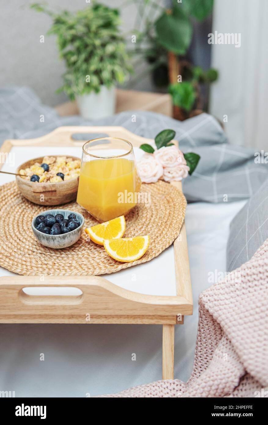 Healthy breakfast. Orange juice, fruits and bowl with granola on a tray ...