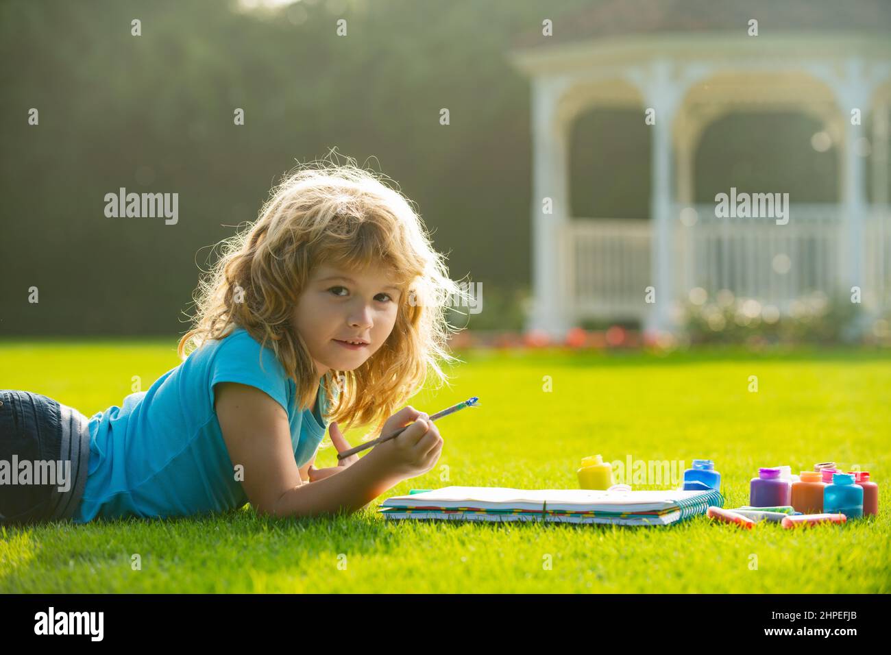 Children draw paint pictures outside, childrens creativity. Child boy ...