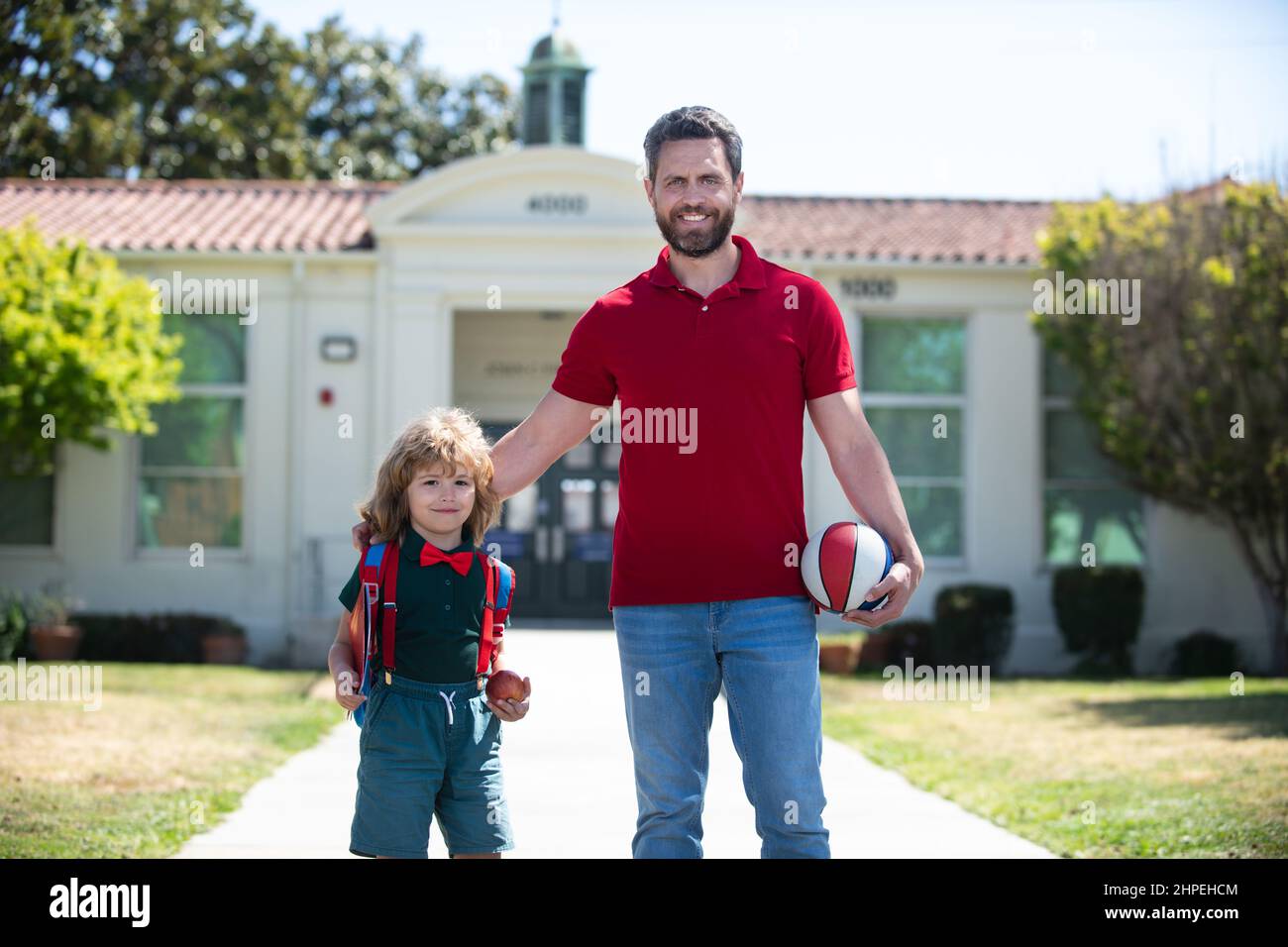 American father and son walking trough school park Stock Photo - Alamy