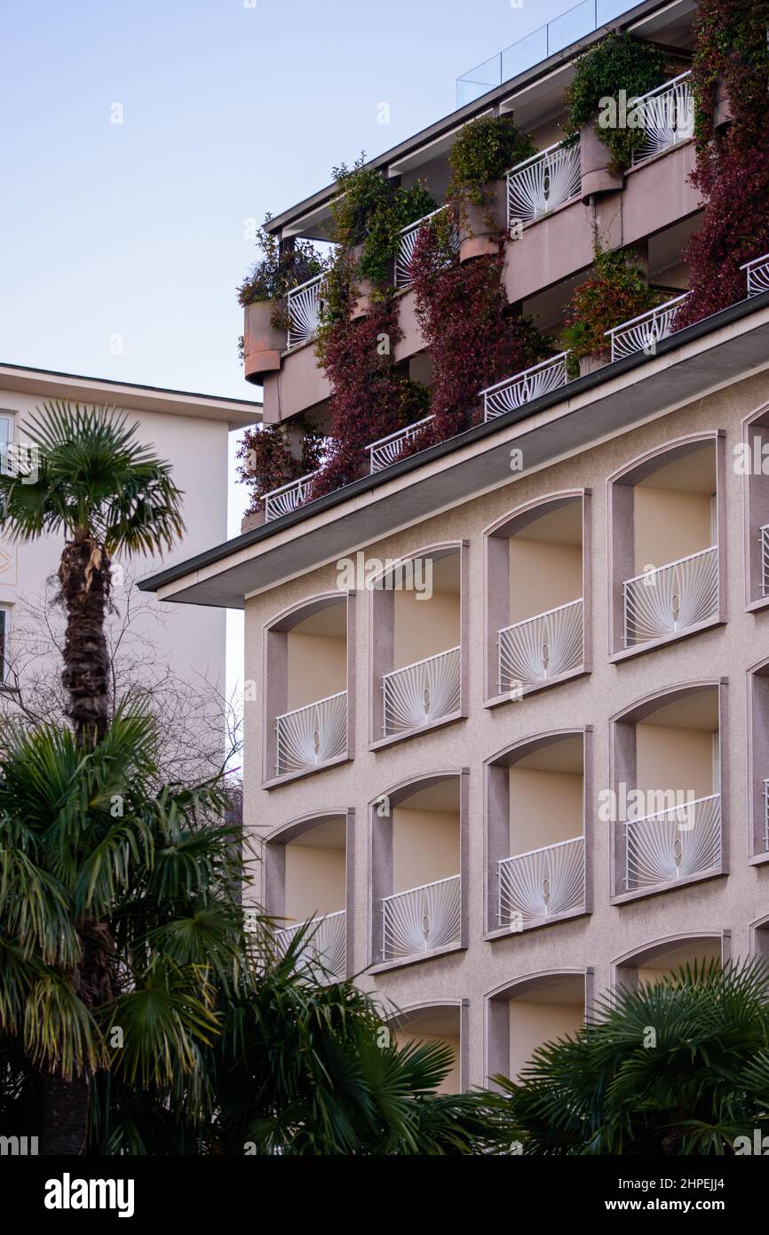 Luxury hotel exterior with plants in the balconies in Stresa, Italy ...
