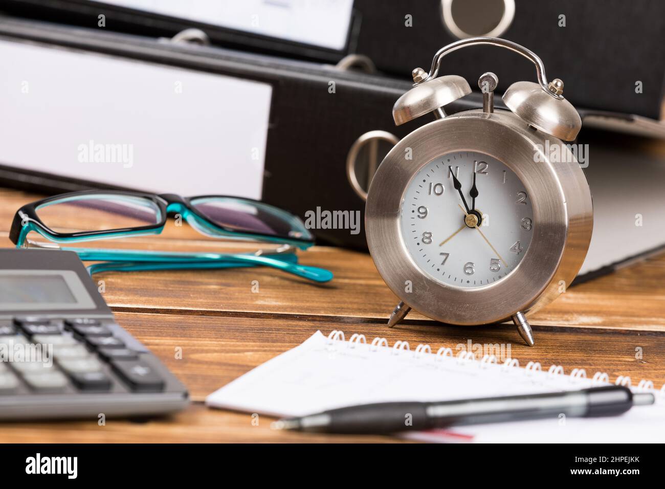 Office desk with calculator, pen, and different objects Stock Photo - Alamy