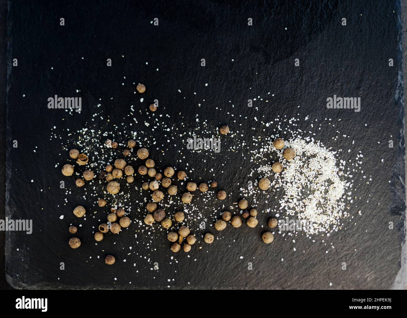 food background with spices. A mixture of peppers and salt on shale ...