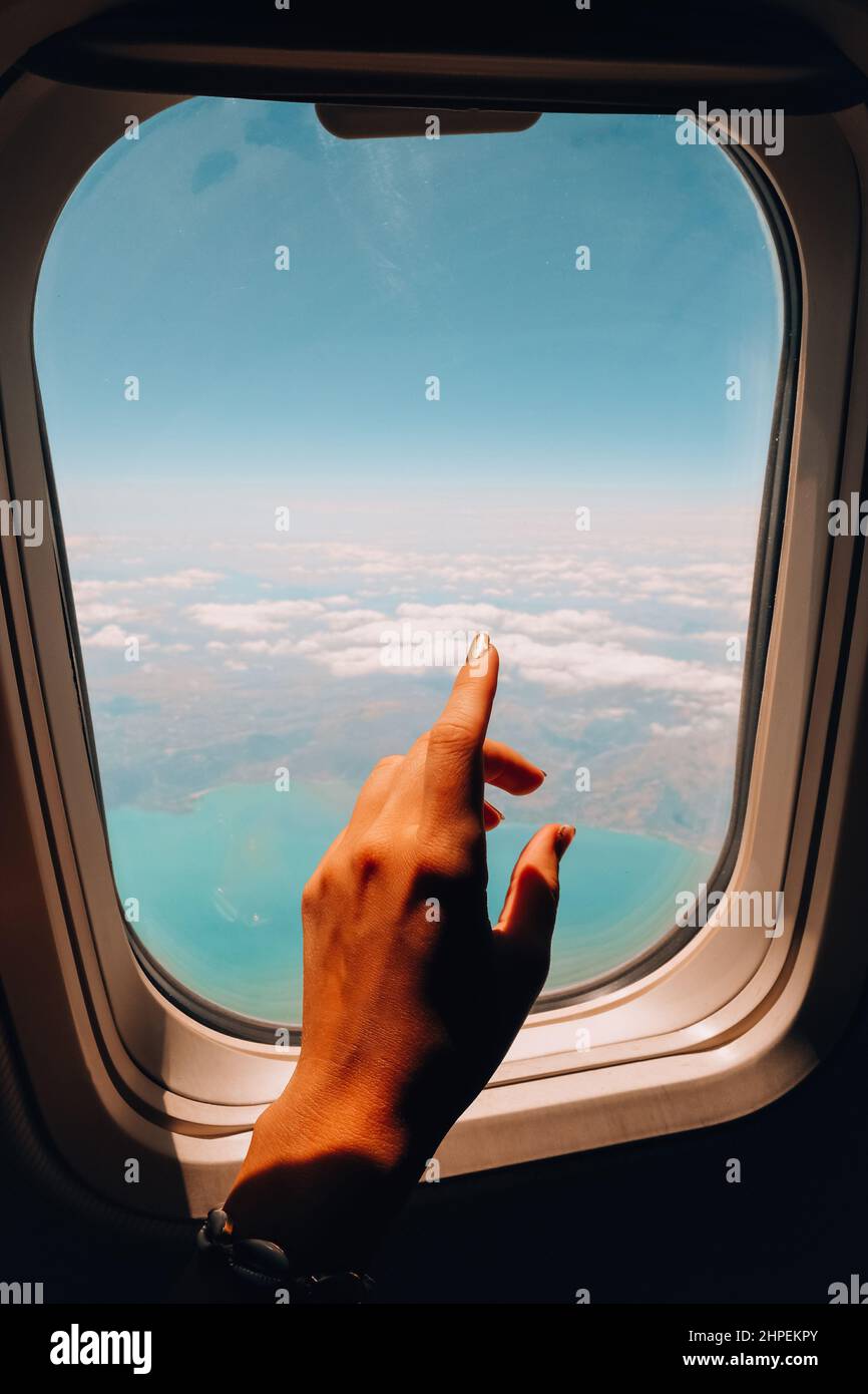 Female hand View from the window of the plane. Airplane, Aircraft ...