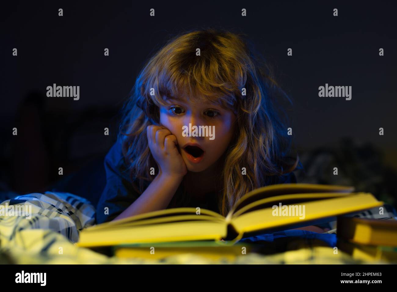 Child reading excidet book. Little boy watching pictures in story book ...