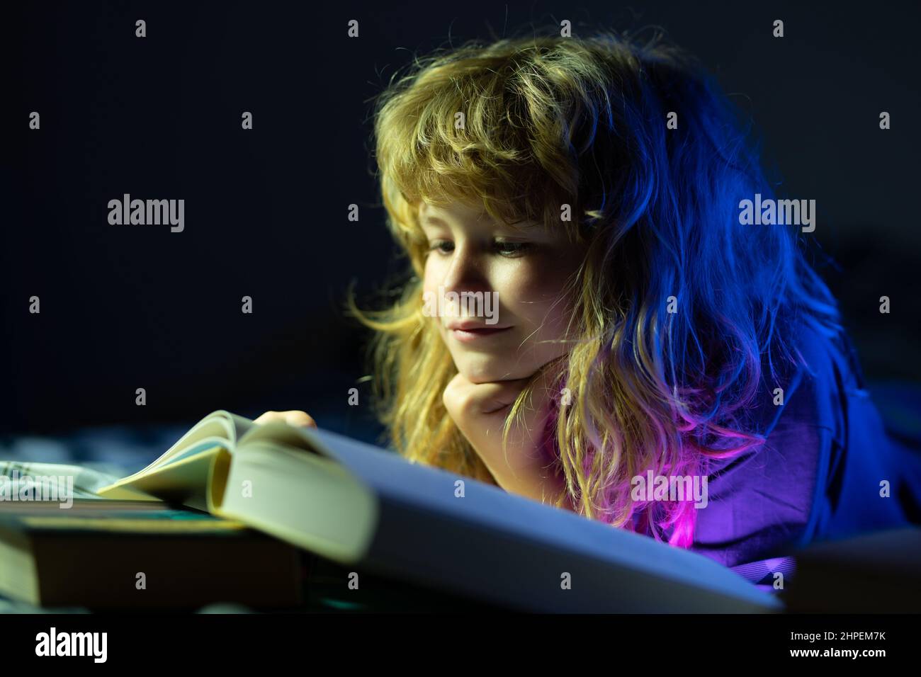 Boy reading bedtime story, dark room photo. Child reading a books. Kids ...