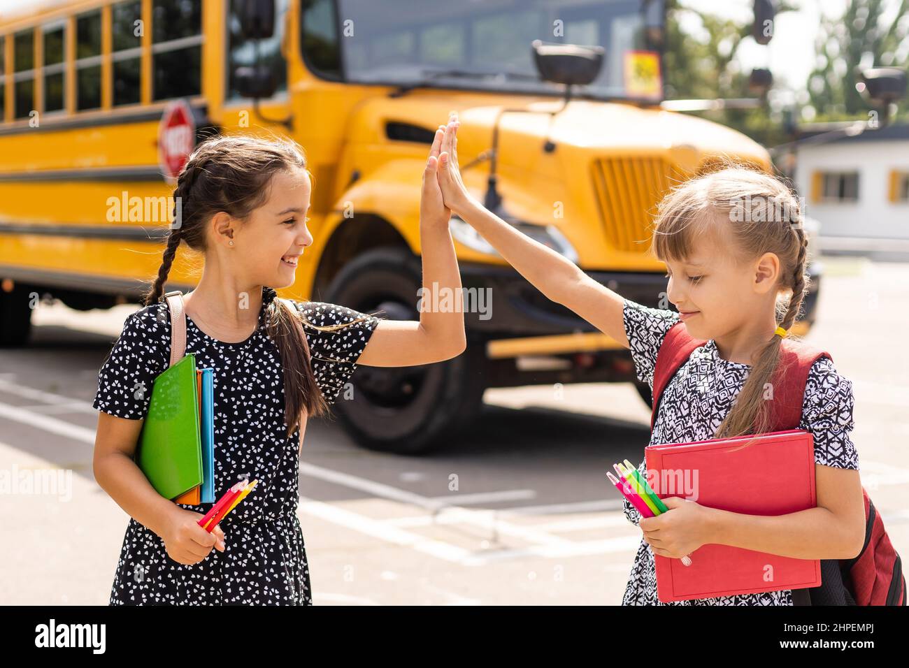 Education: Smiling Student Friends Ready For School next to school bus ...