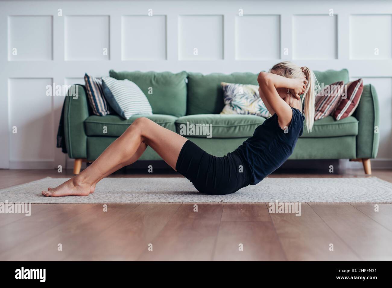 Fitness woman doing sit ups. Young woman making abdominal exercises at ...