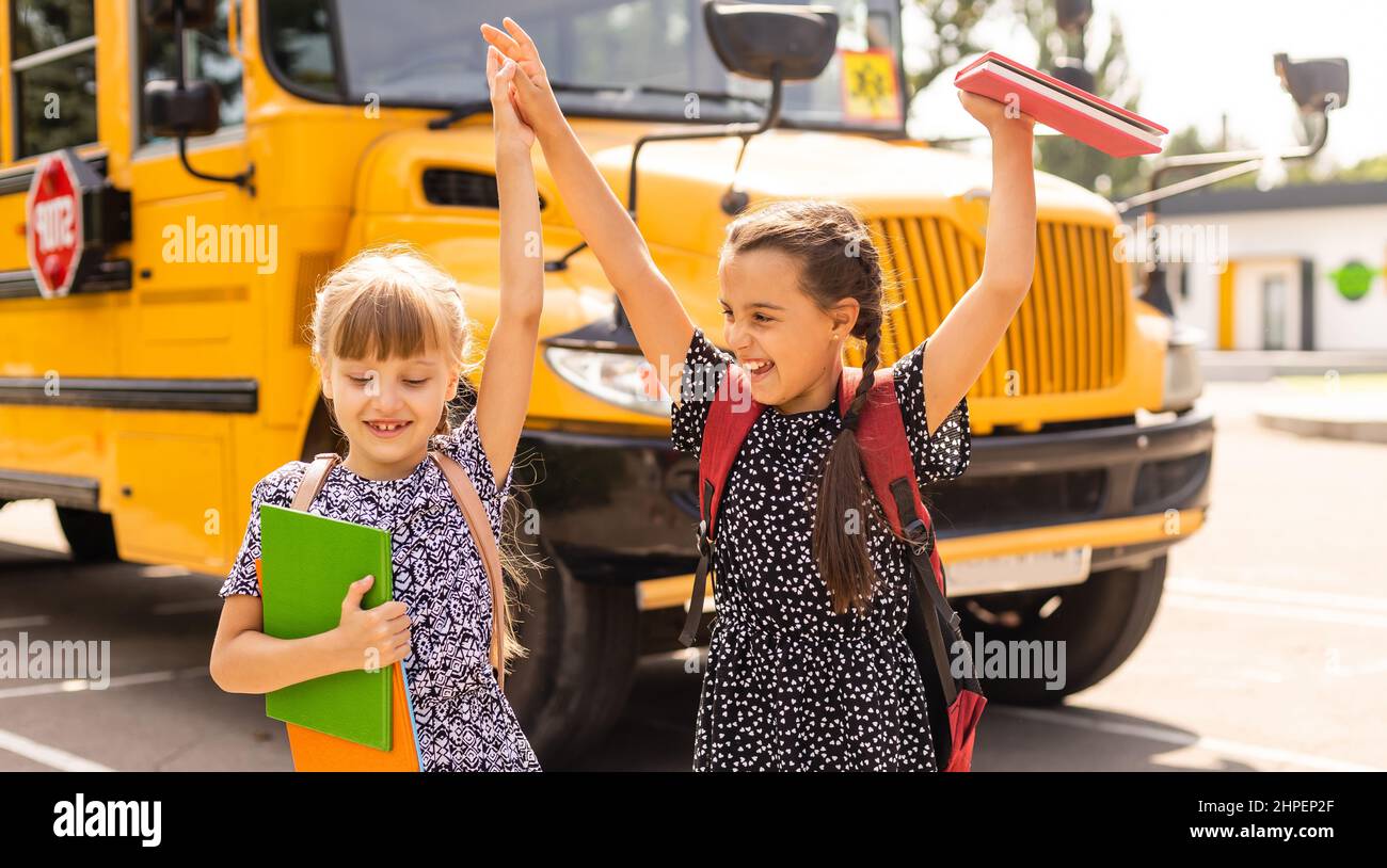 Education: Smiling Student Friends Ready For School next to school bus ...