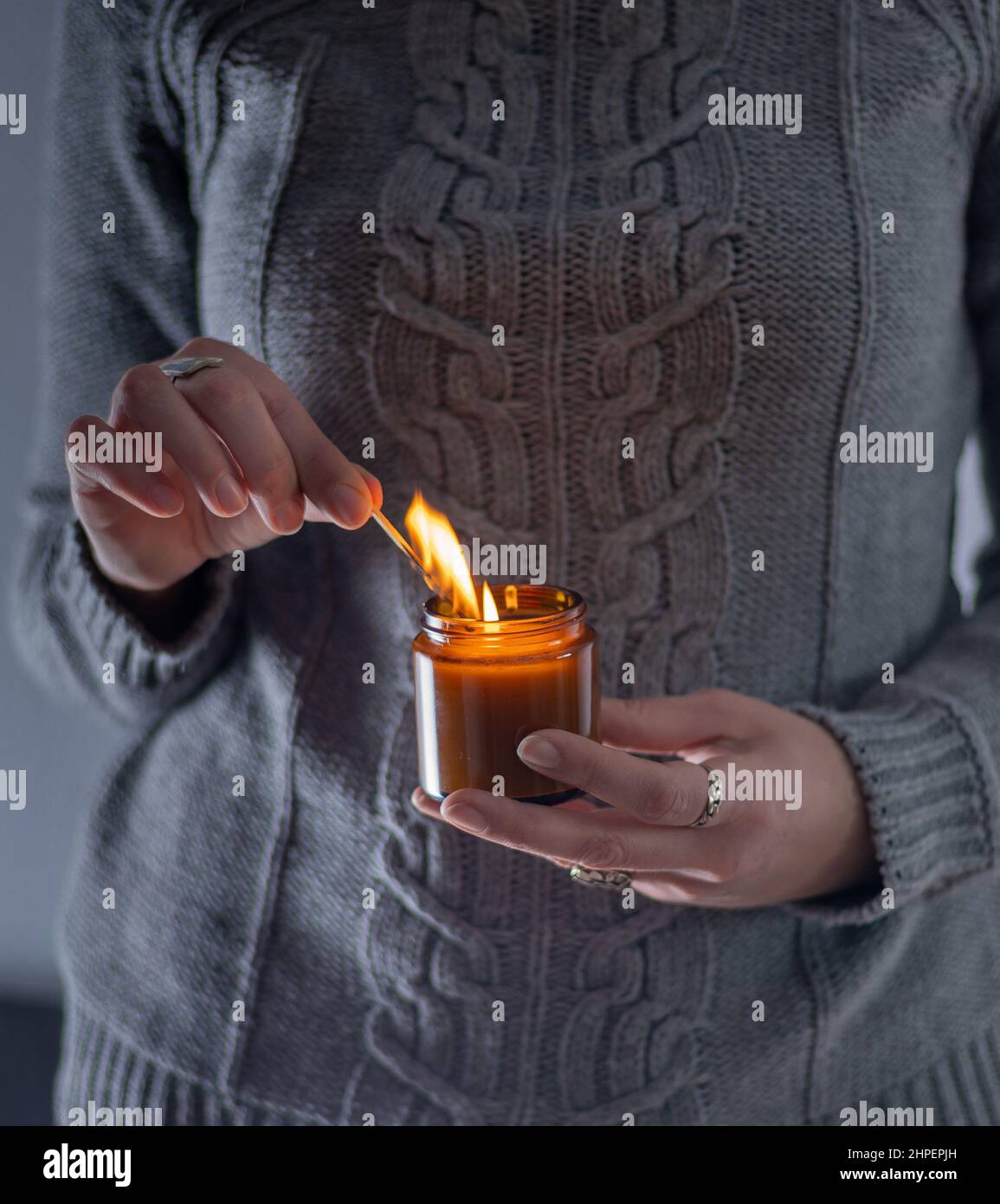 Light and hold a soy candle in your hands. Candle in a jar ...