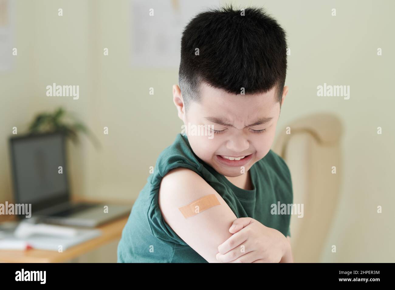 Asian little boy crying after getting an injection he sitting at ...