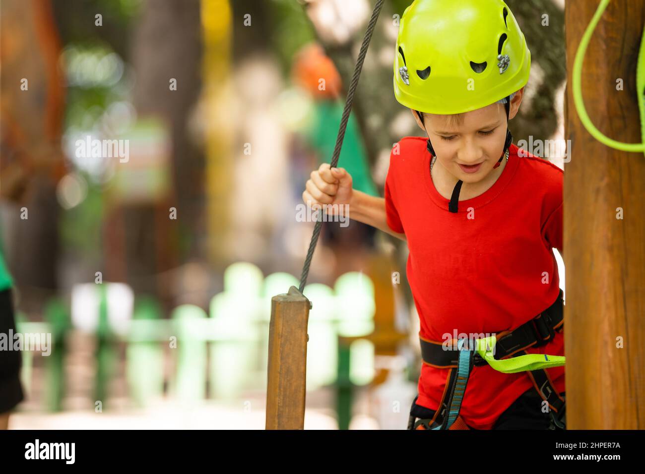 Boy climber walks on the rope bridge Stock Photo - Alamy
