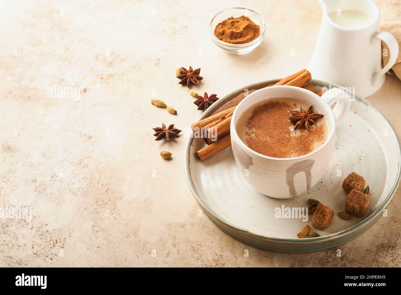 Masala tea. Masala chai spiced tea with milk and spices on light warm ...