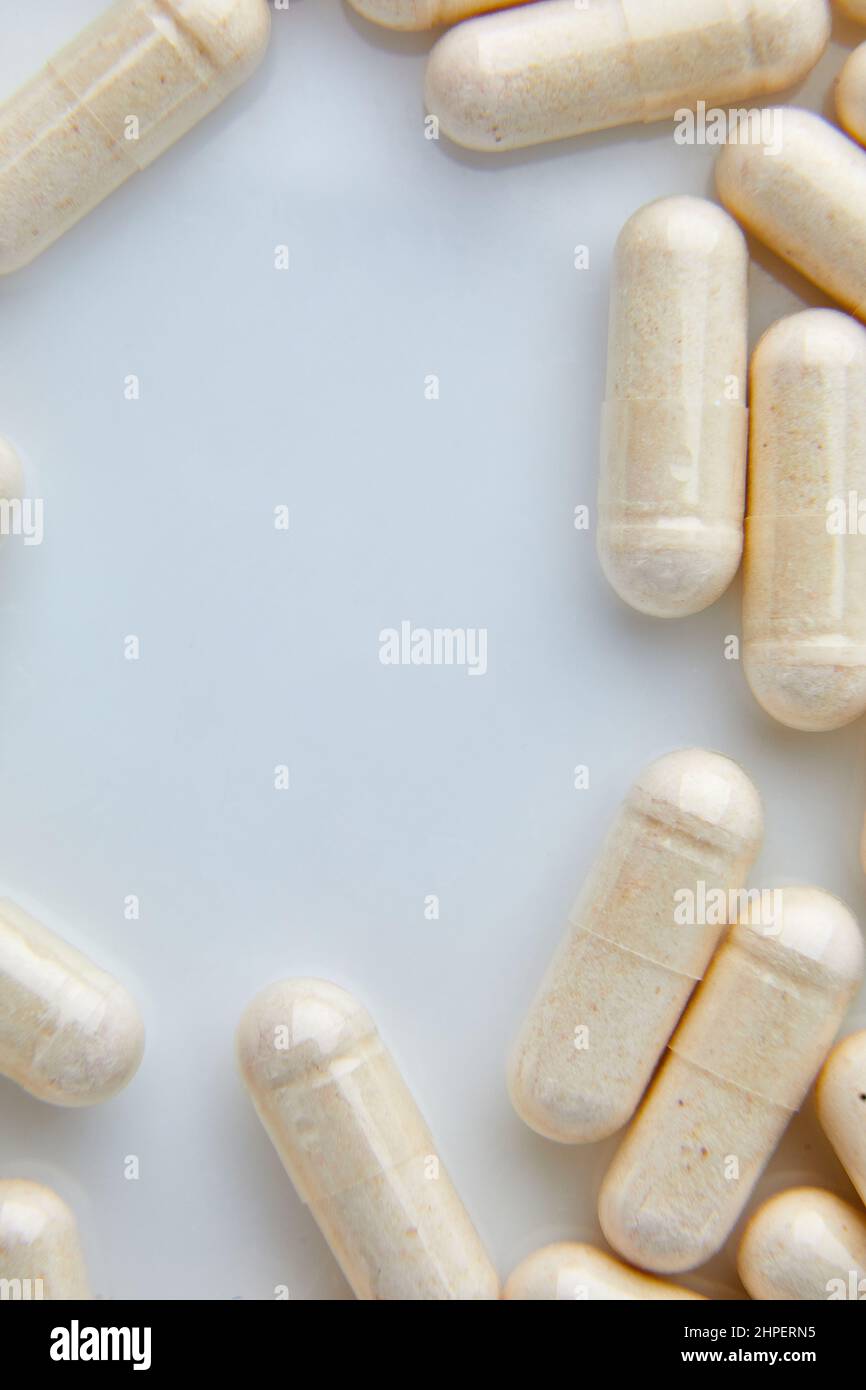 Flat lay macro White beige capsule pills, tablets, top view, close up ...