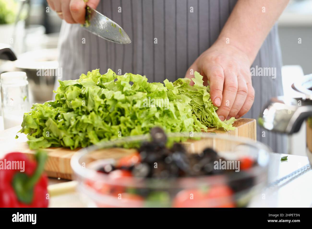 Chef hands cutting green fresh lettuce ingredient, person chopping ...