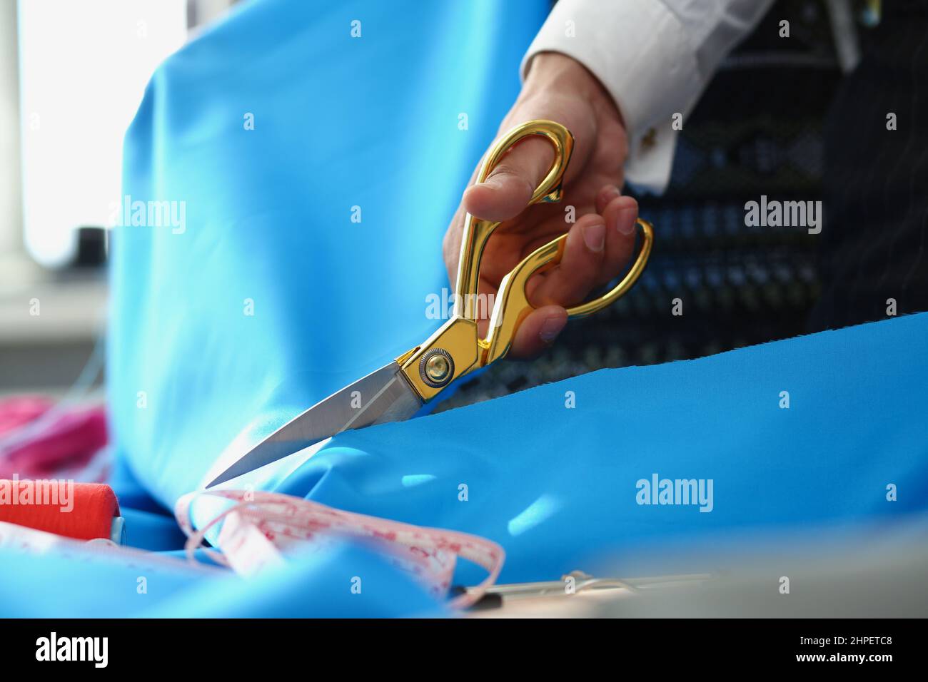 Person cutting blue cotton hi-res stock photography and images - Alamy