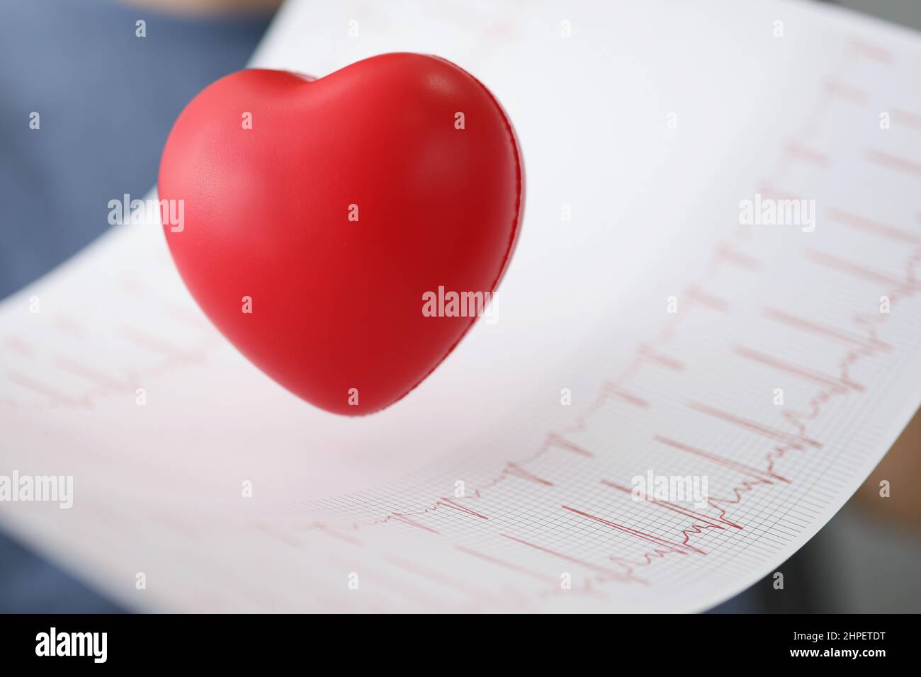 Red plastic heart with electrogram result, professional diagnostic ...