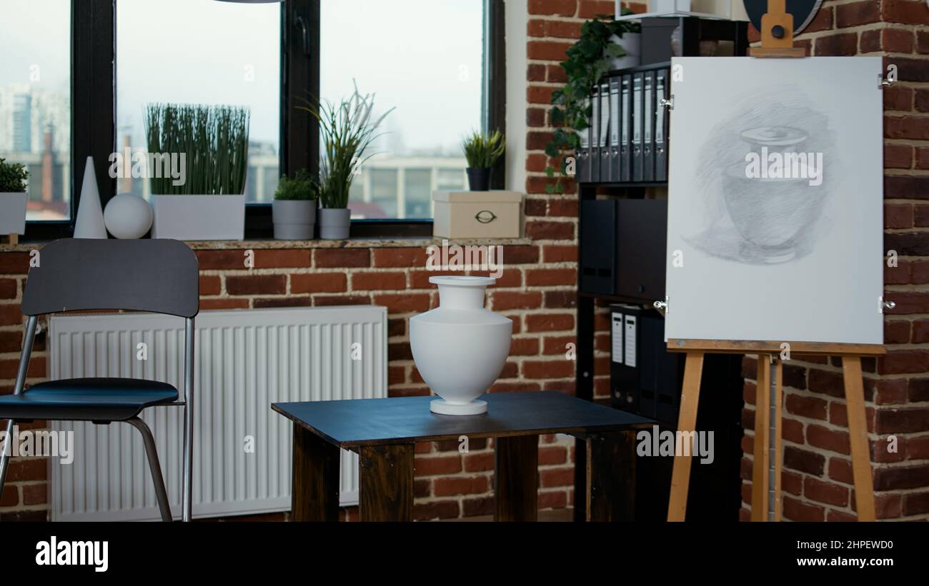 Empty art drawing class with wooden easel and white canvas. No people ...