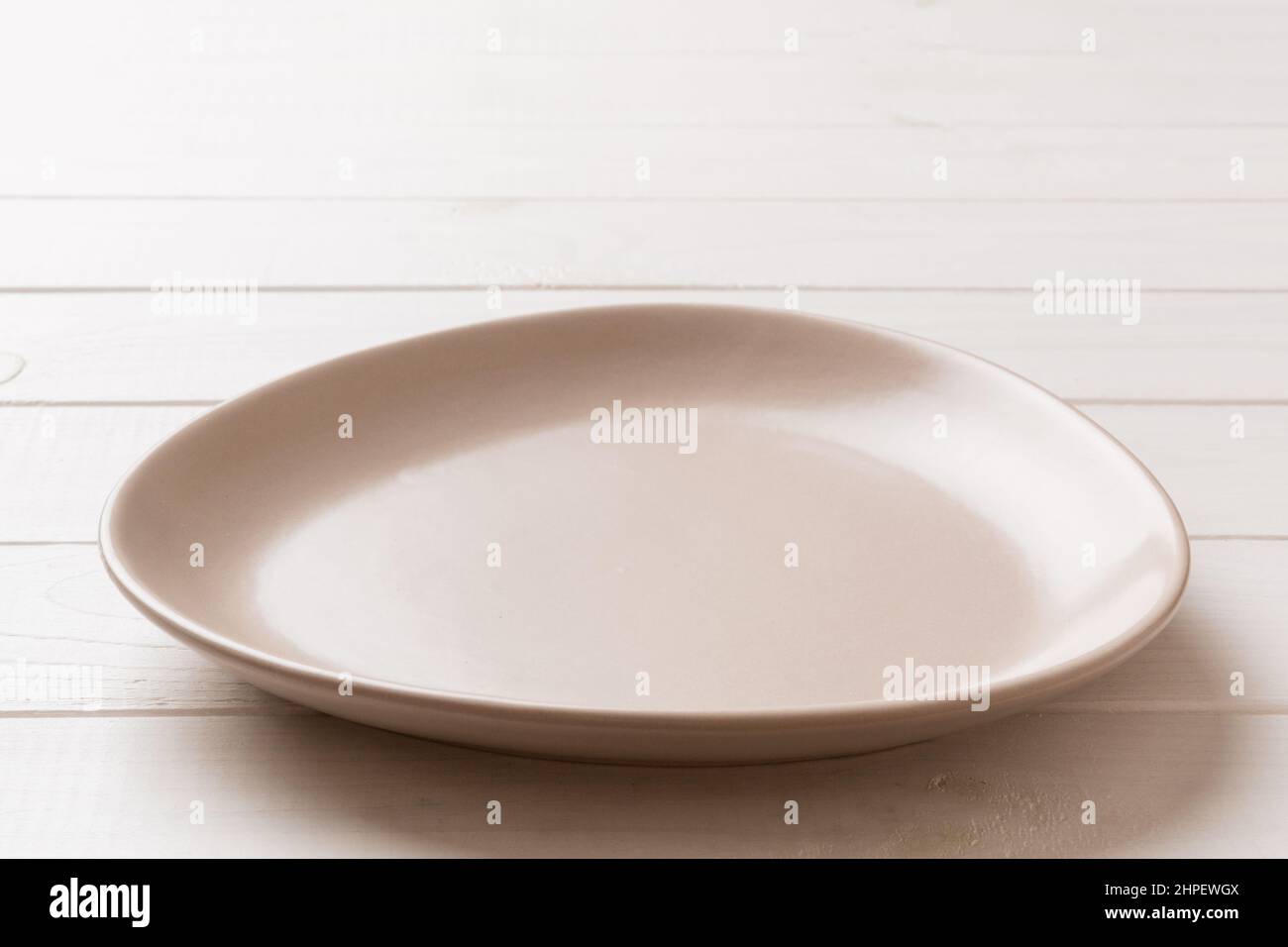 Perspective view of empty pink plate on wooden background. Empty space ...