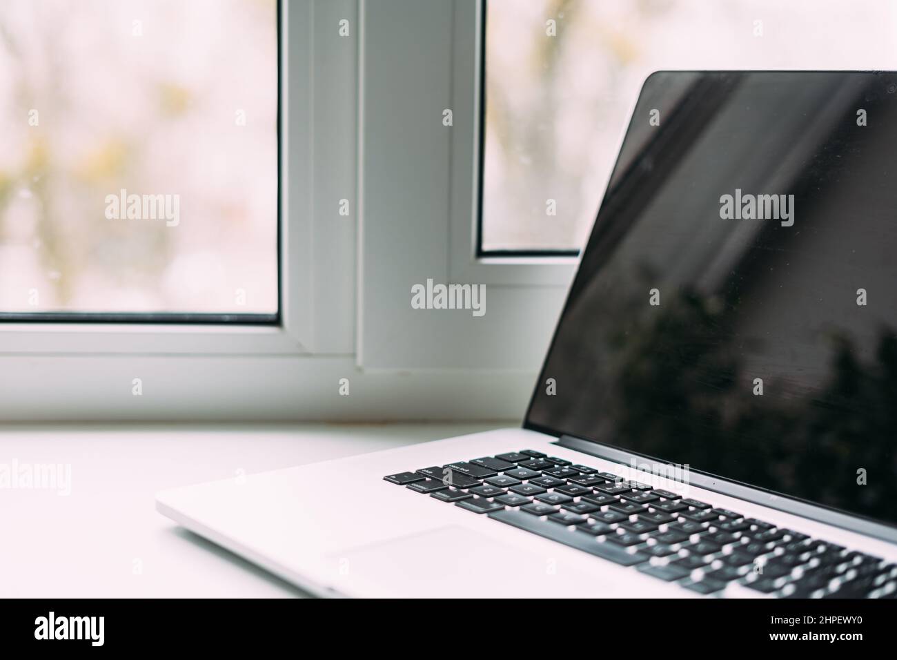 Laptop on window at home. Mockup screen of computer. Remote work or ...