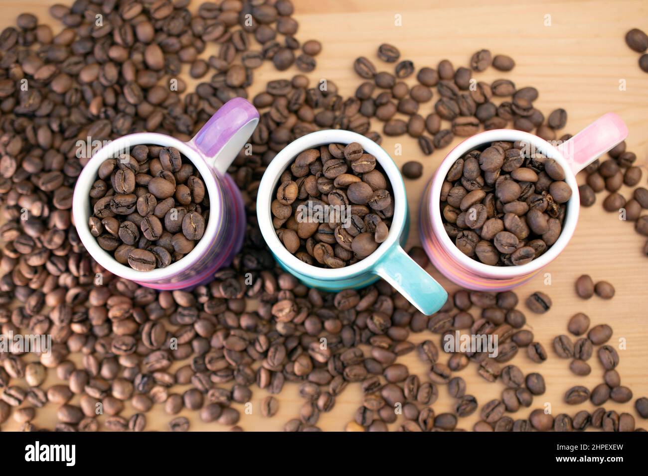 Coffee beans in cute and colorful small espresso cups Stock Photo - Alamy
