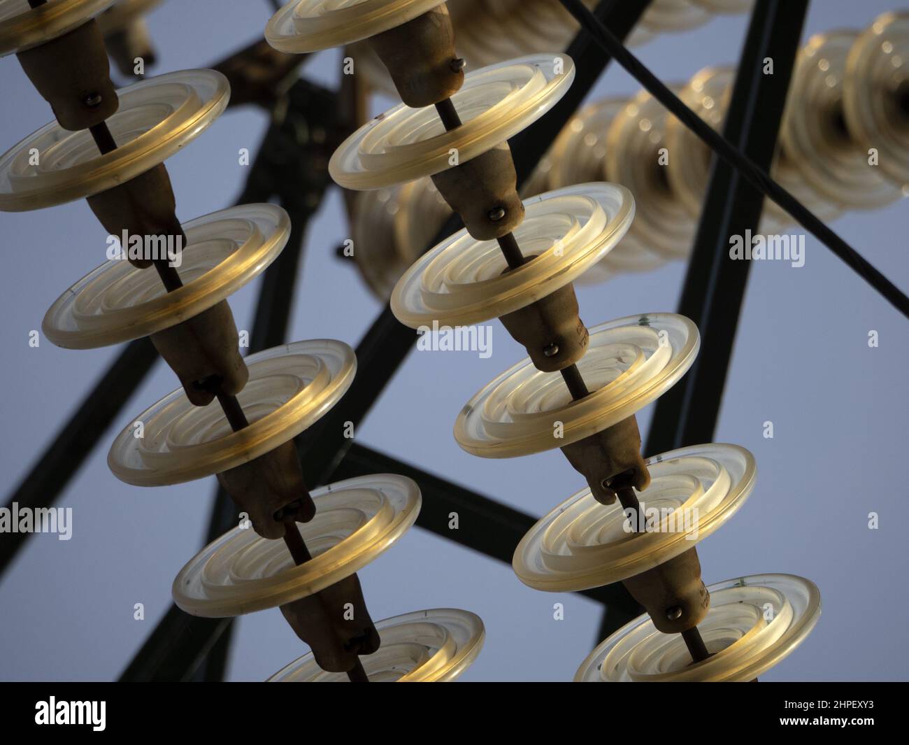 High Voltage electric wires cap and pin insulator detail on blue sky ...