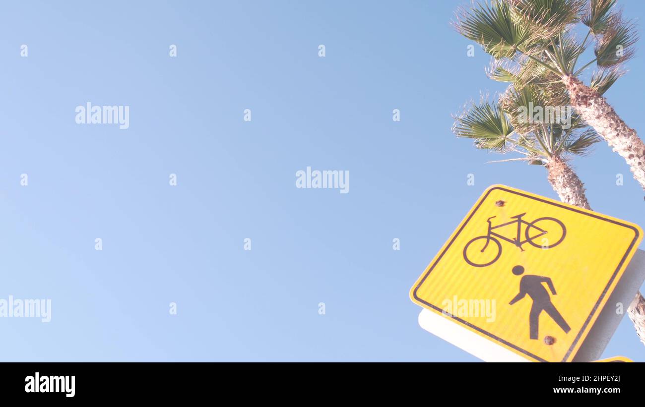 Pedestrian and bike crossing warning yellow road sign on city street ...