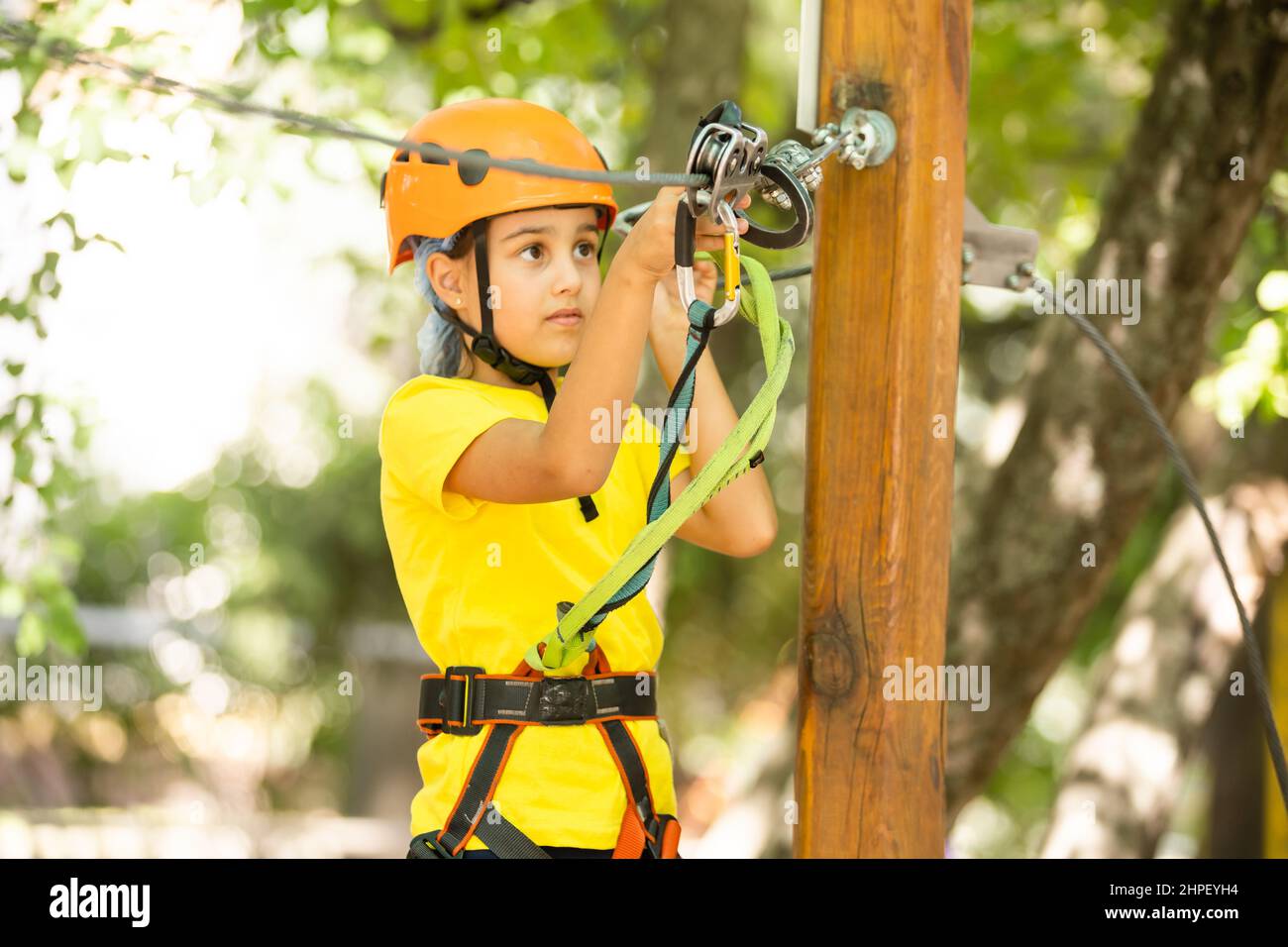 Happy child climbing in the trees. Rope park. Climber child. Early ...