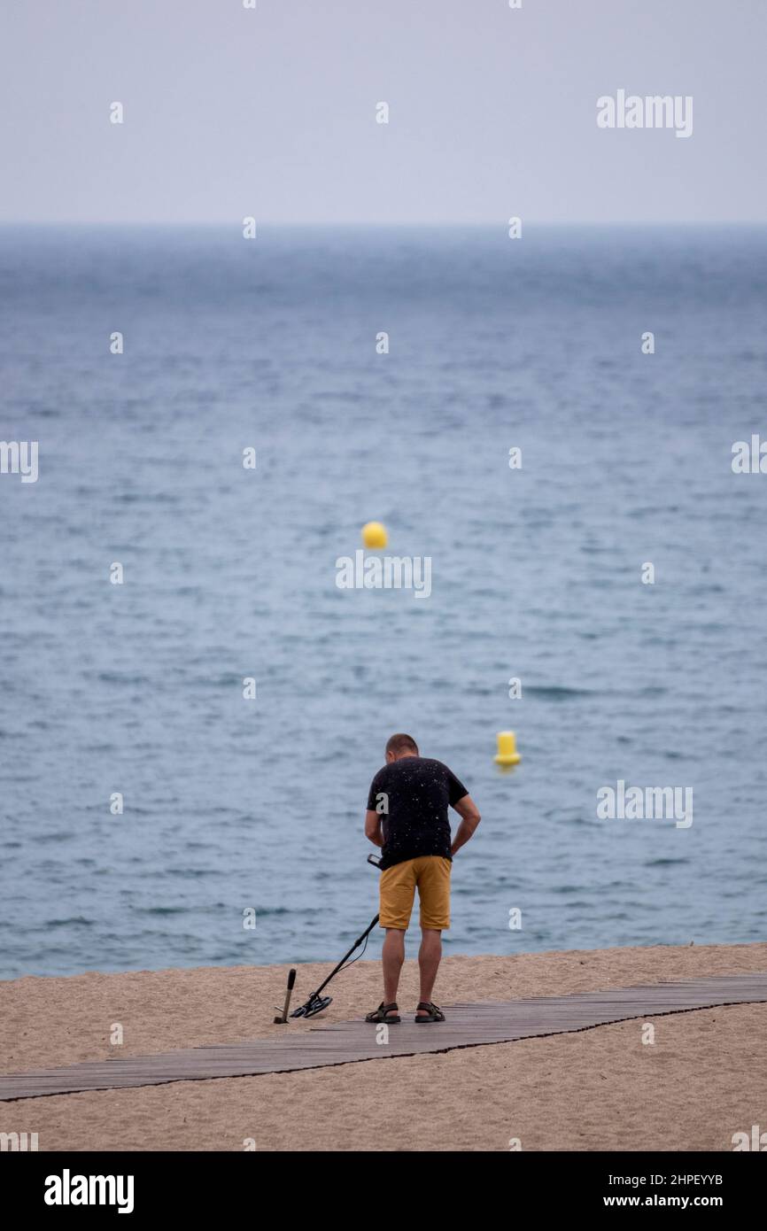 Metal detector searching on sandy hi-res stock photography and images ...