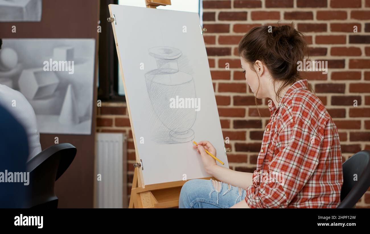 Creative woman using pencil to sketch contemporary drawing, attending ...