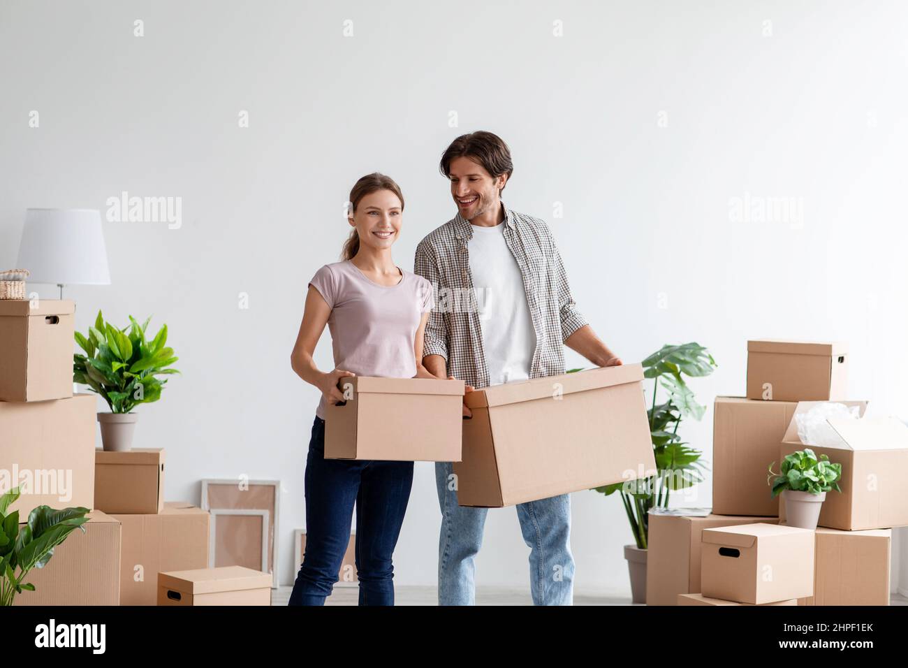 Glad millennial european male and female in casual carry cardboard ...