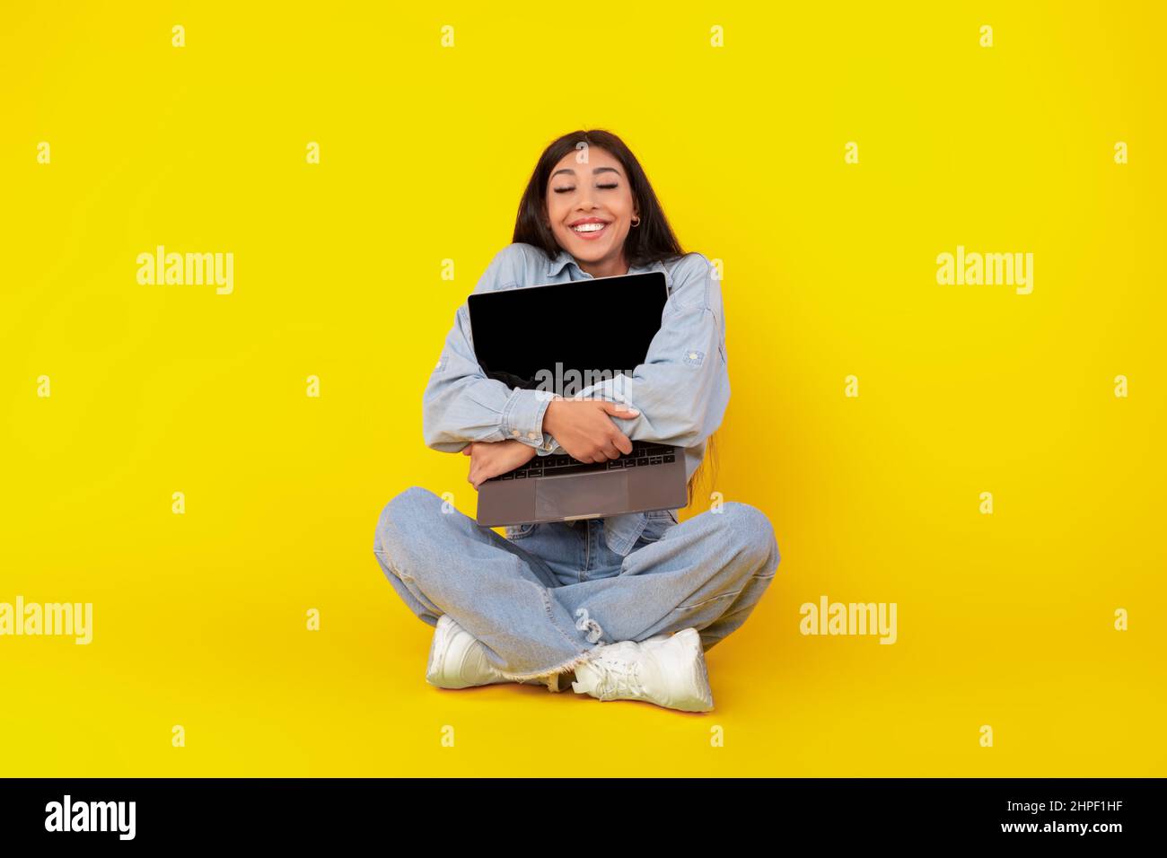 Technology Lover. Excited woman hugging laptop at studio Stock Photo ...