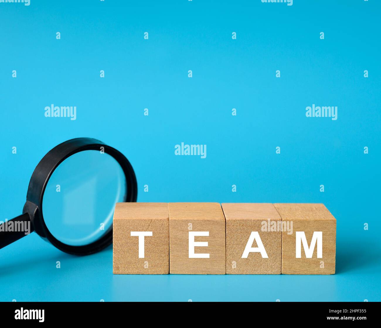 Team building concept with Wooden cubes and magnifying glass Stock ...