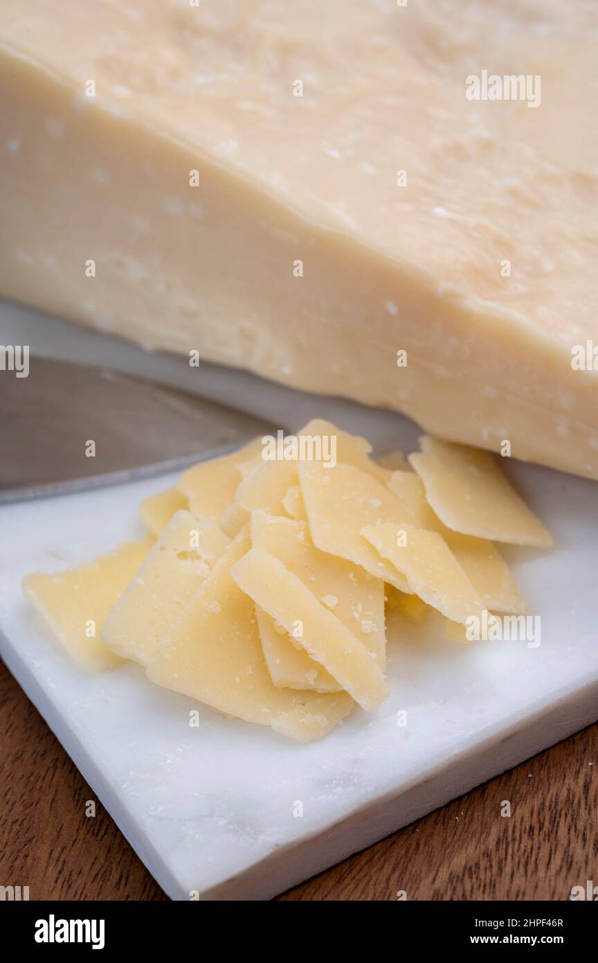 Flakes of parmesan cheese, italian hard parmigiano-reggiano cheese from ...