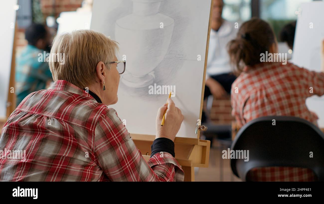 Old student using pencil to draw inspiration model at lesson, creating ...