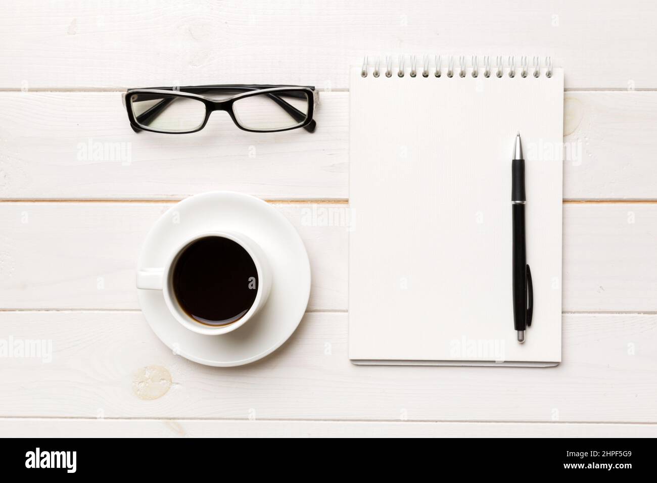 Modern office desk table with notebook and other supplies with cup of ...