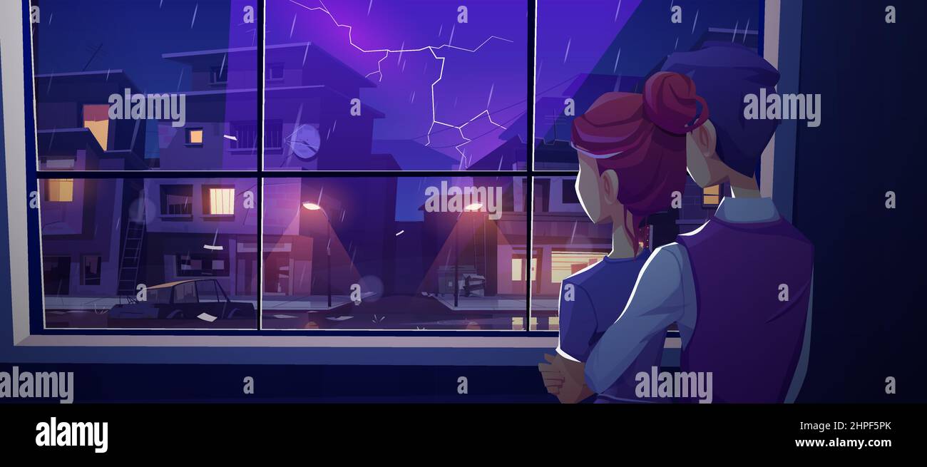 Young couple stand at window rear view looking on night ghetto street ...