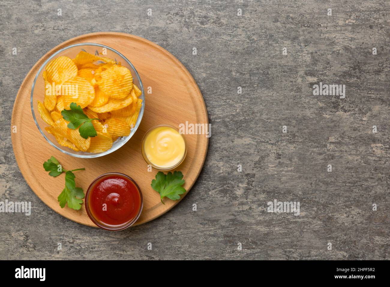 Top view chips with sause in bowl on colored background, top view with ...