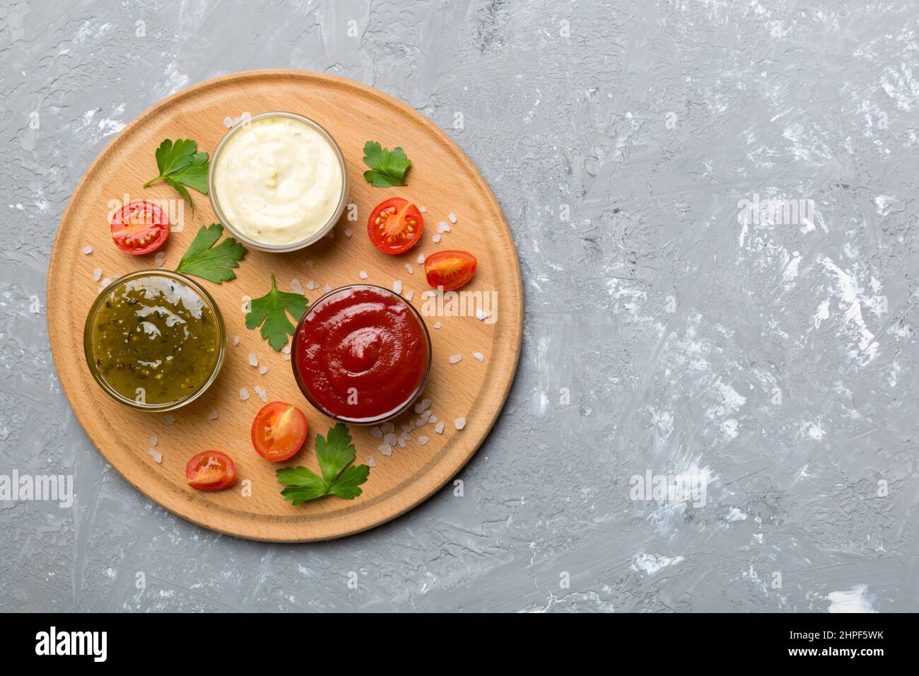 Many different sauces and herbs on table, flat lay top view. sauces on ...