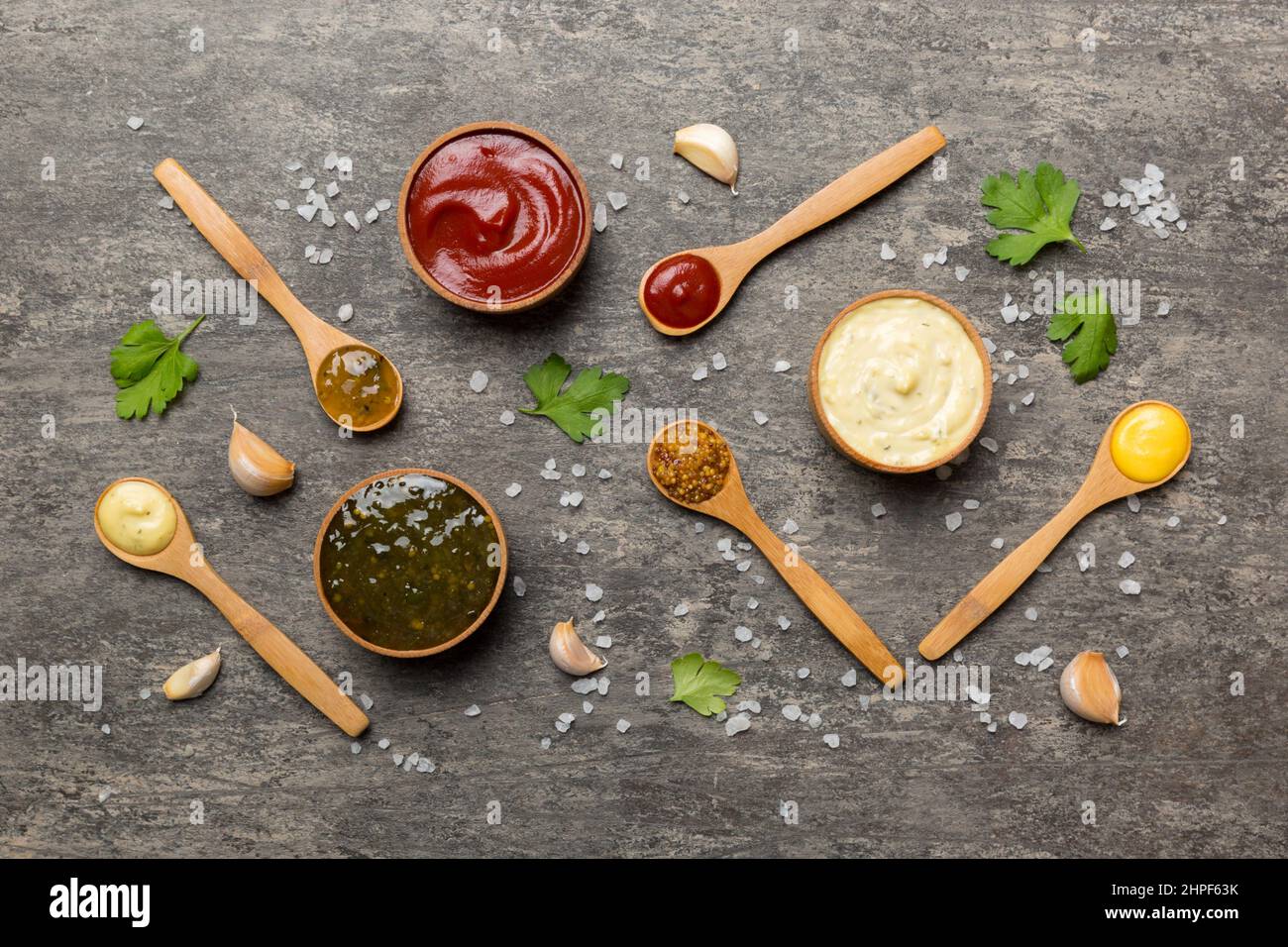 Different sauces in spoons on table background, flat lay top view Stock ...