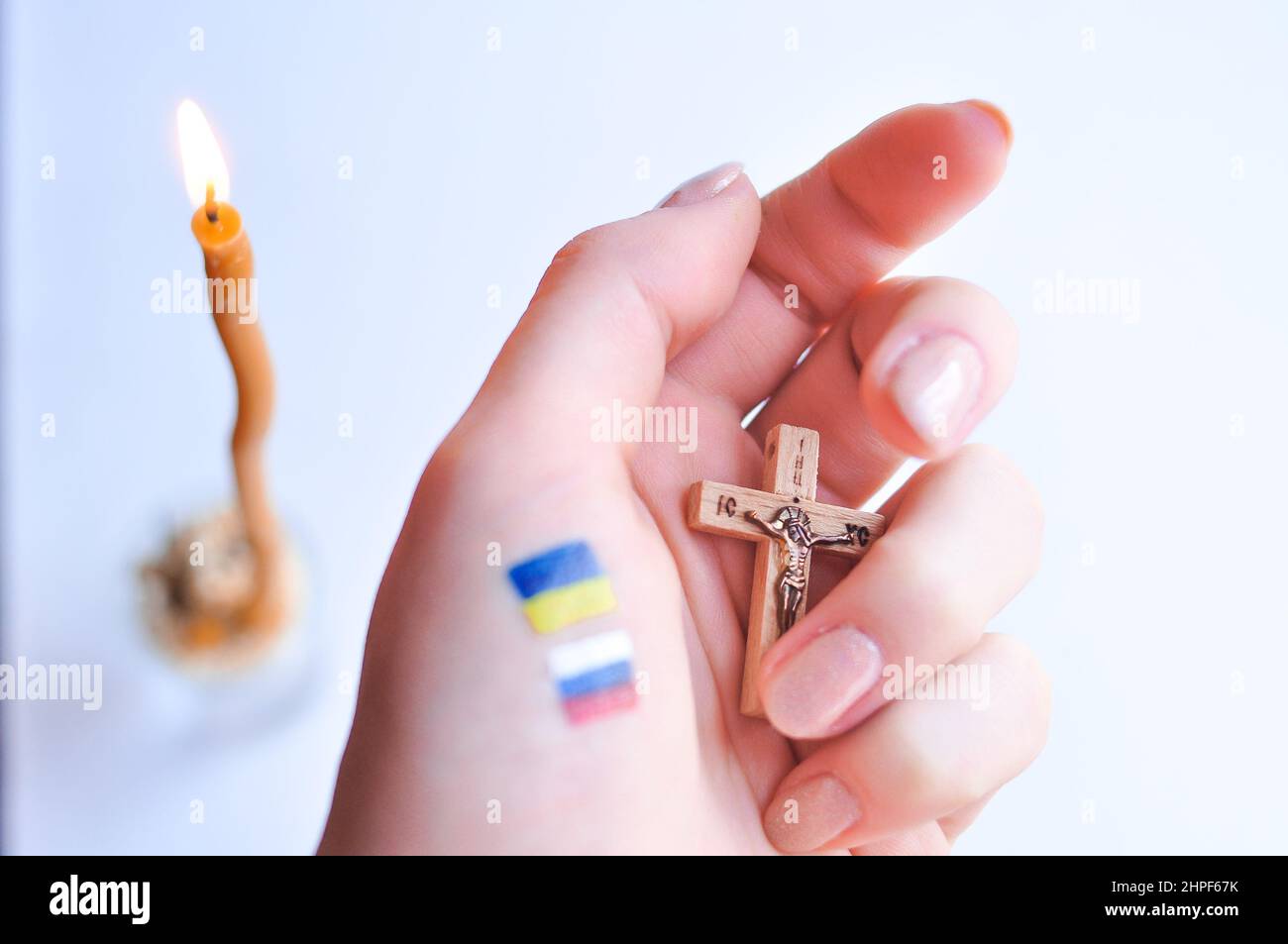Orthodox Christ and drawned Russian and Ukrainian flags in hand Stock ...
