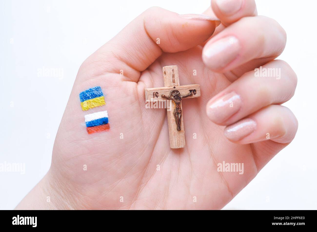 Orthodox Christ and drawned Russian and Ukrainian flags in hand Stock ...