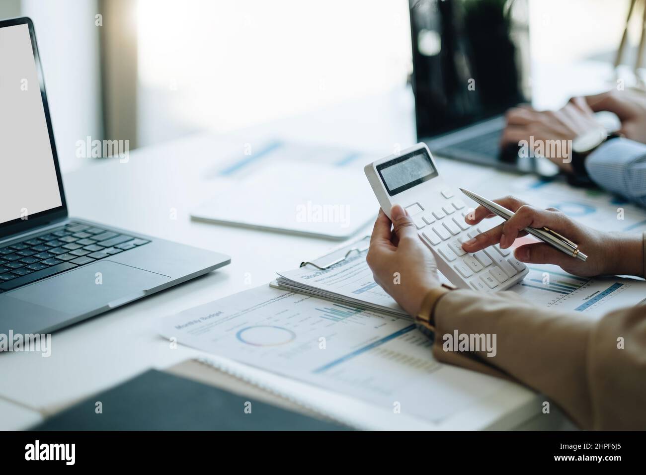 businesswoman accountant hand working on calculator to calculate ...