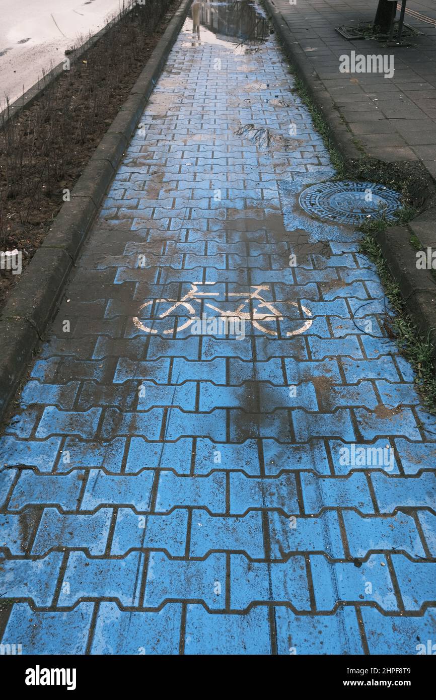 A muddy blue bike path after a rainy day Stock Photo - Alamy