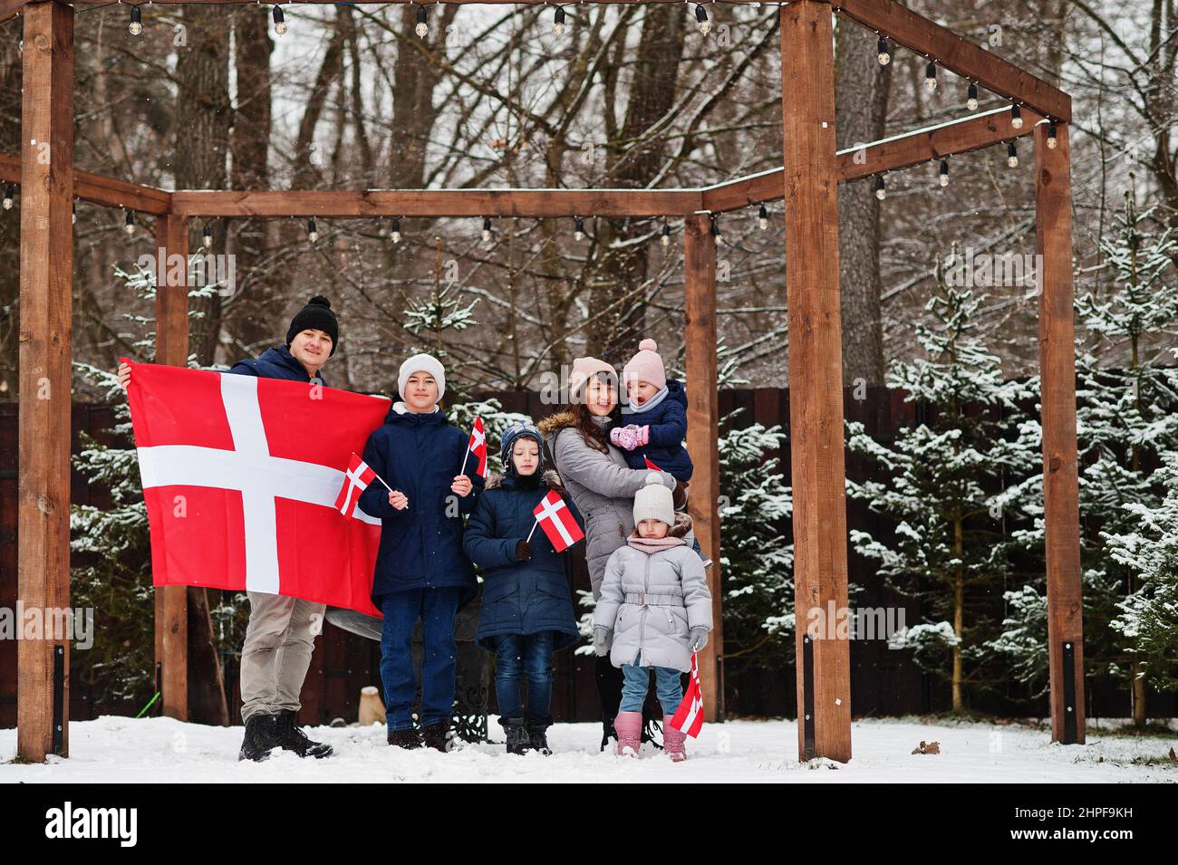 Family with Denmark flags outdoor in winter. Travel to Scandinavian ...