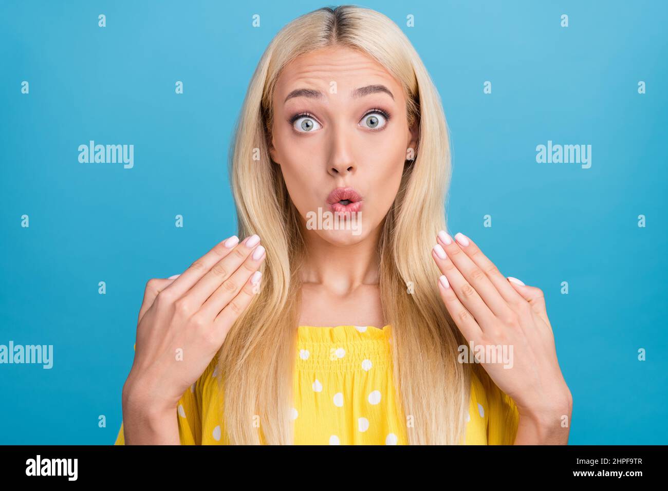 Photo of impressed millennial blong lady hands up wear yellow top ...