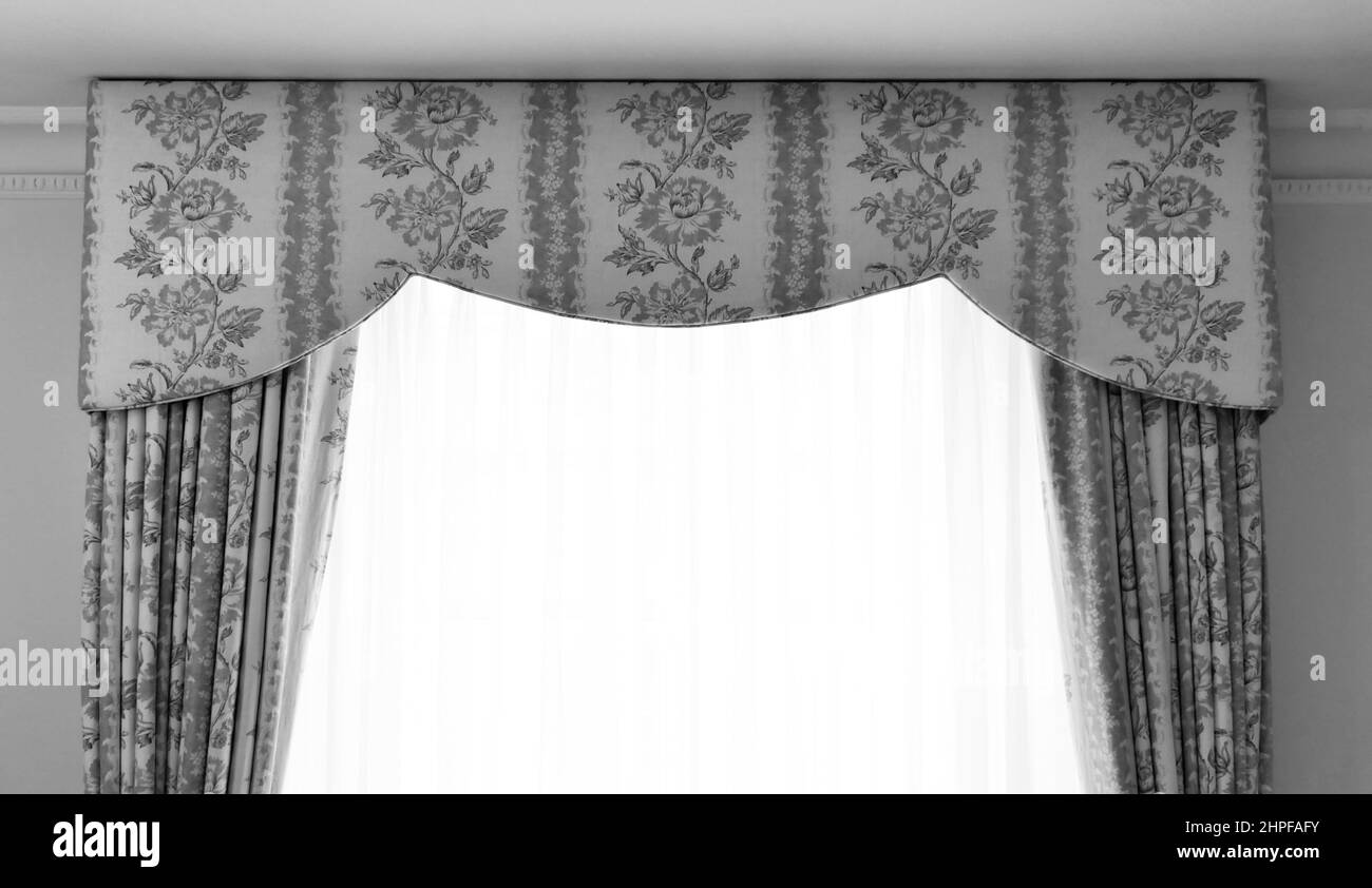 Traditionally dressed window with fabric pelmet in patterned fabric ...