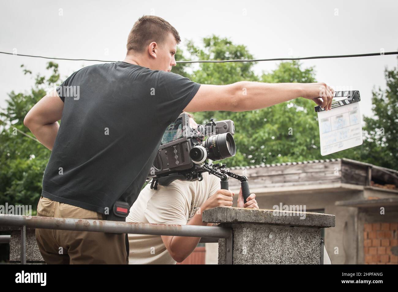 Behind the scenes. Cameraman shooting the film scene with his camera on ...