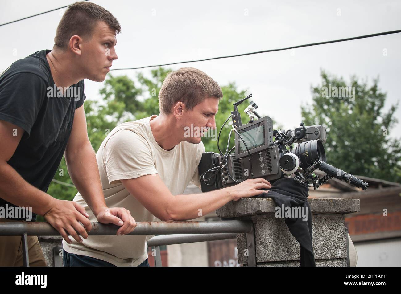 Behind the scenes. Cameraman shooting the film scene with his camera on ...